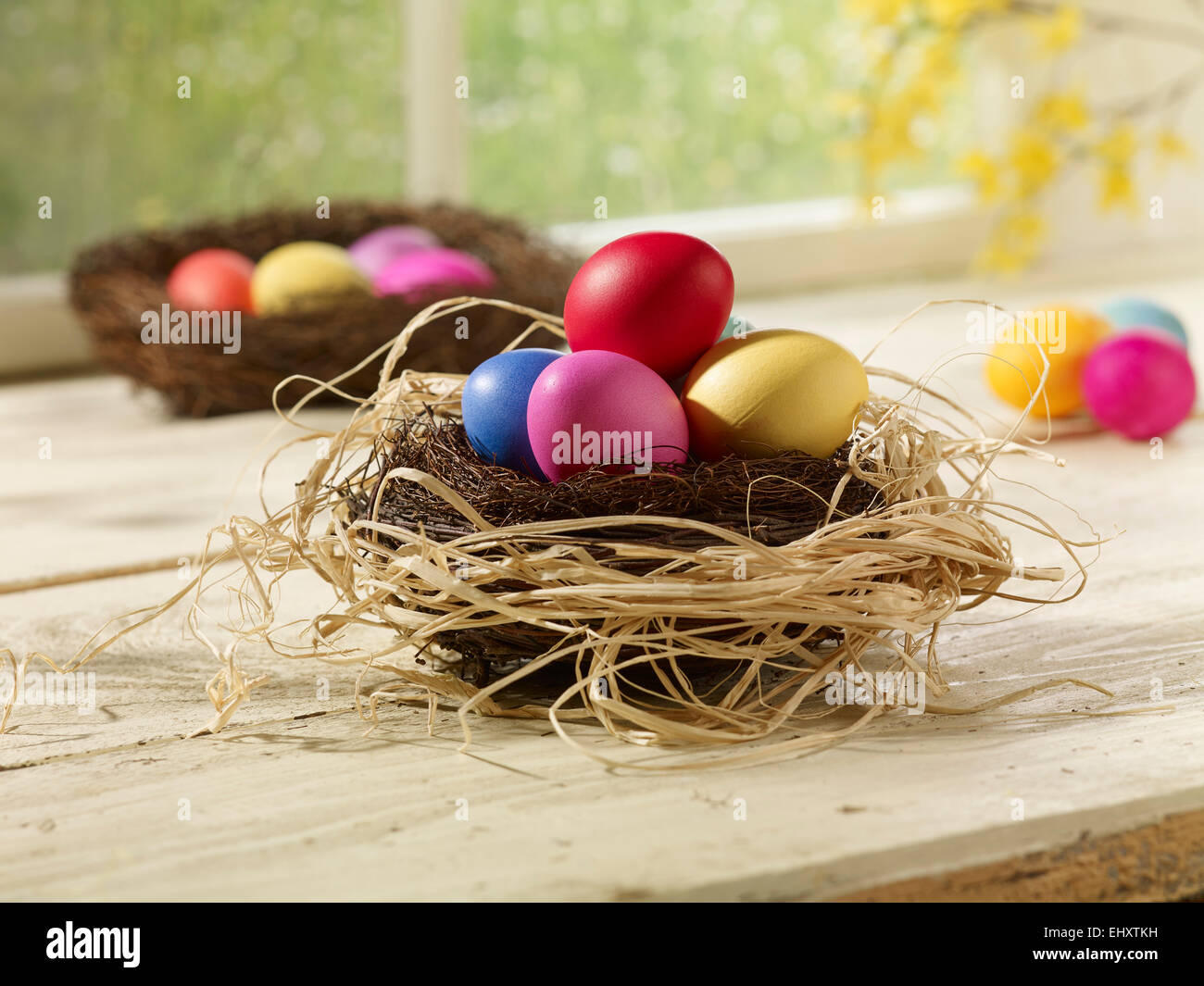 Eastern, Easter nest with coloured eggs Stock Photo - Alamy