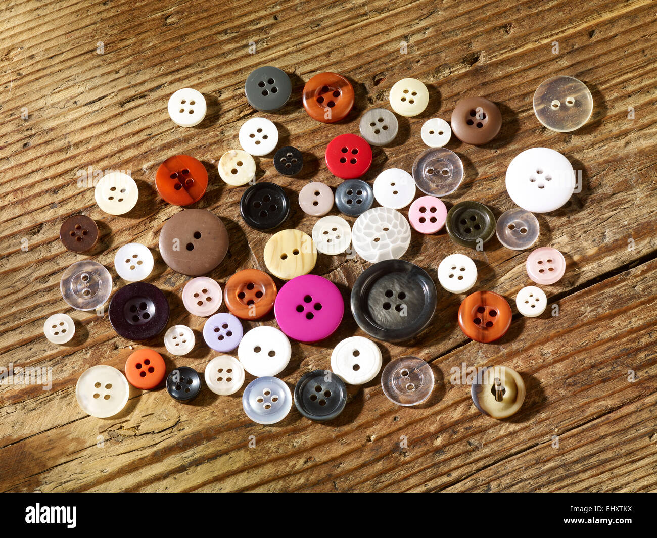 Collection of different buttons on wood Stock Photo - Alamy