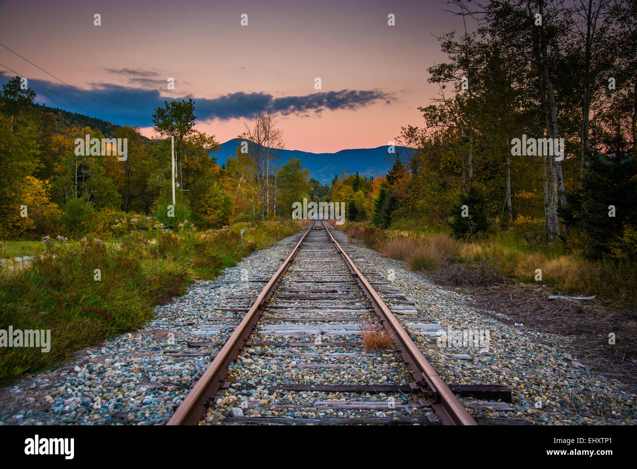 Railroad track and distant mountains at sunset seen in White Mountain ...