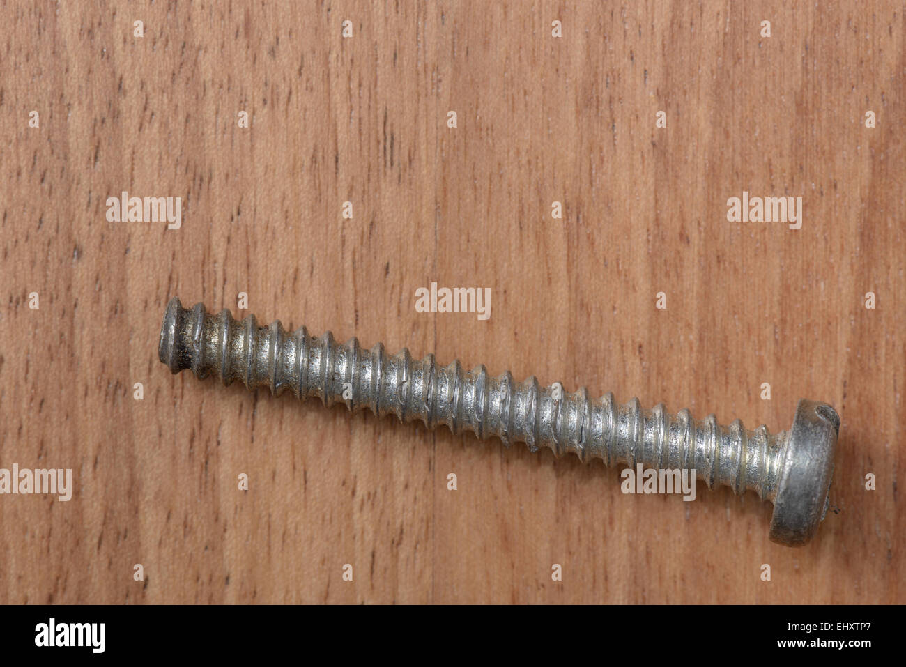 One bolt on wood blur background Stock Photo - Alamy
