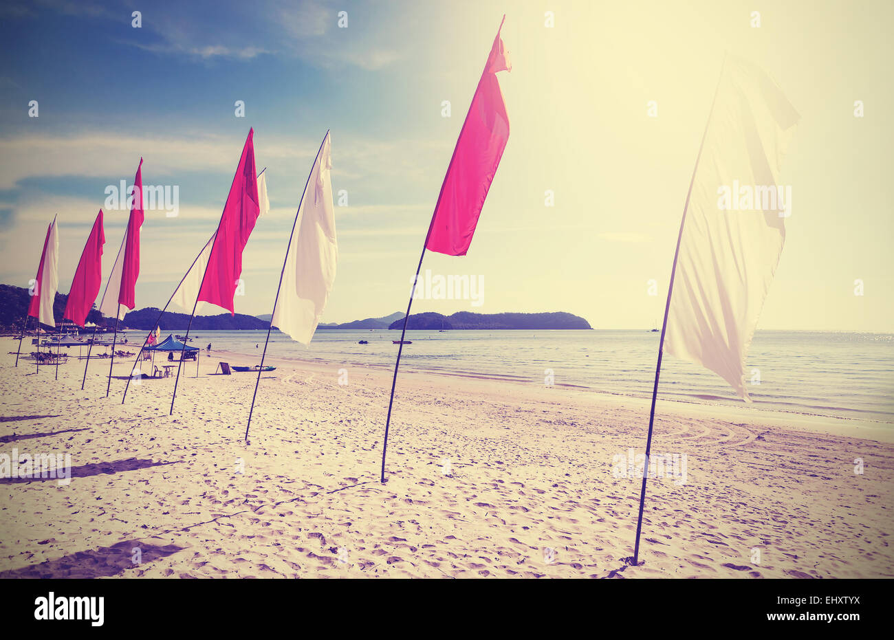 Retro filtered picture of flags on a beach. Concept for summer and ...