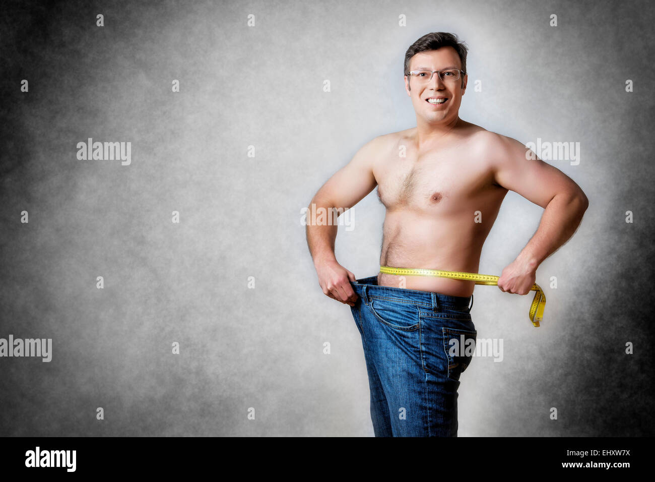 Image of a man in blue jeans with measuring tape who has lost body ...