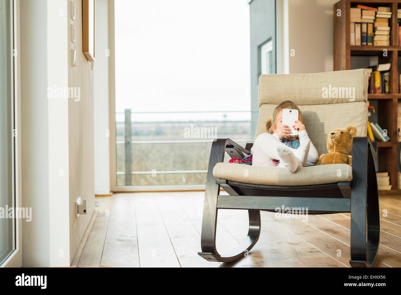 Girl sitting in rocking chair hi-res stock photography and images - Alamy