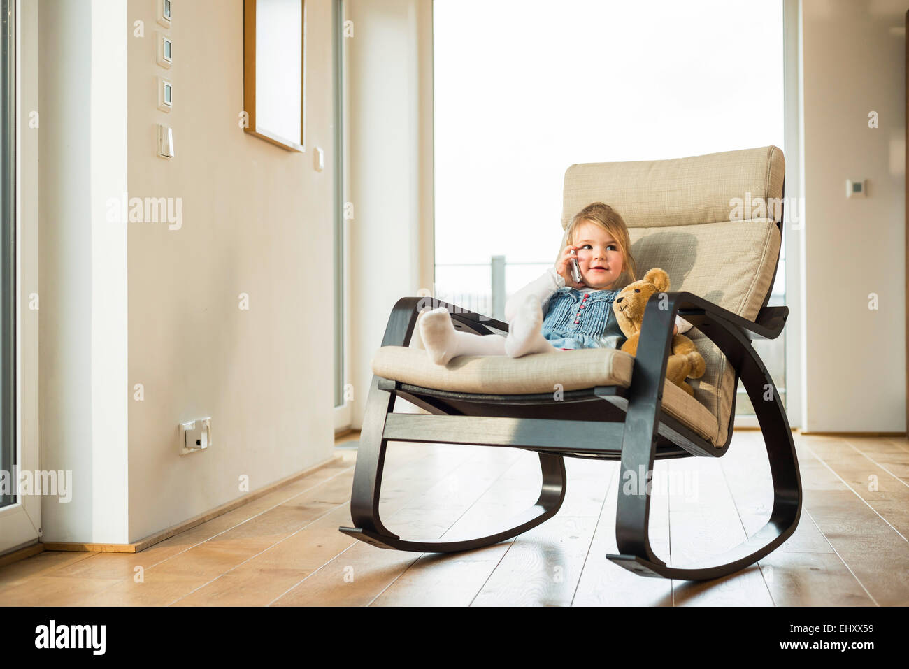 Girl sitting in rocking chair hi-res stock photography and images - Alamy