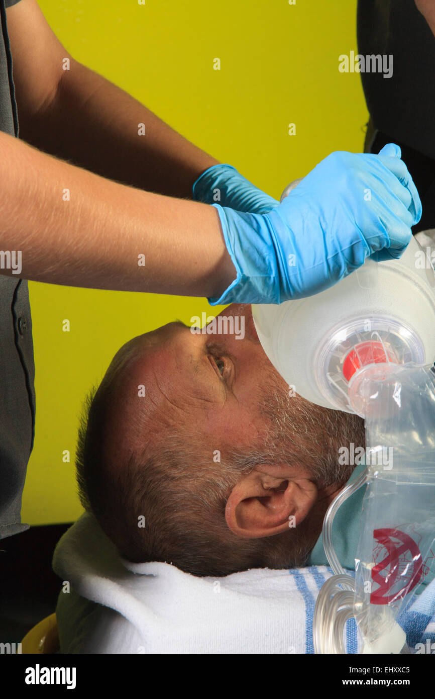 Paramedic who make a cardio-pulmonary resuscitation to a person Stock ...