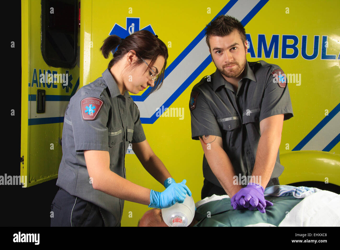Paramedic who make a cardio-pulmonary resuscitation to a person Stock ...