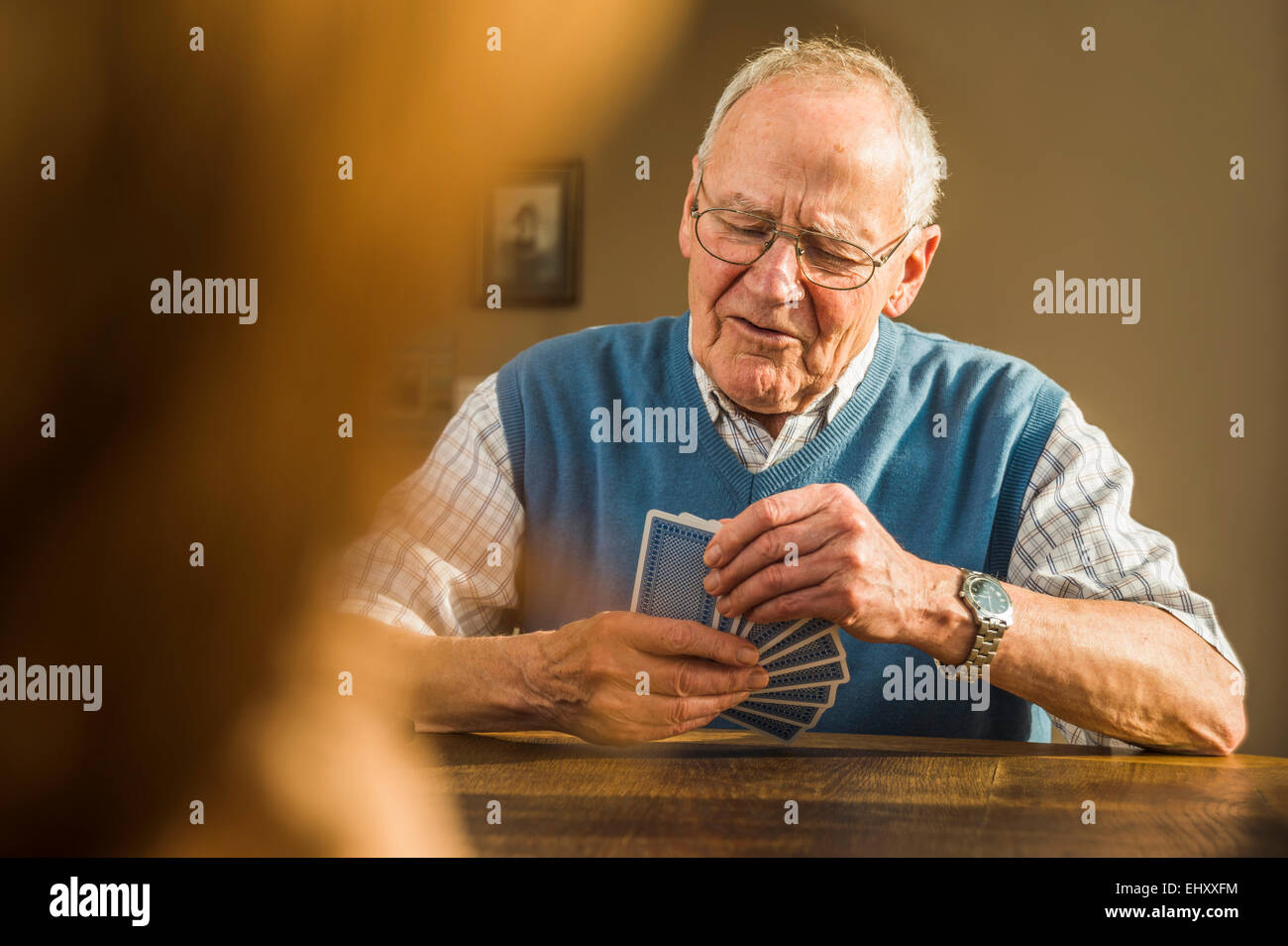 Senior man playing cards Stock Photo - Alamy