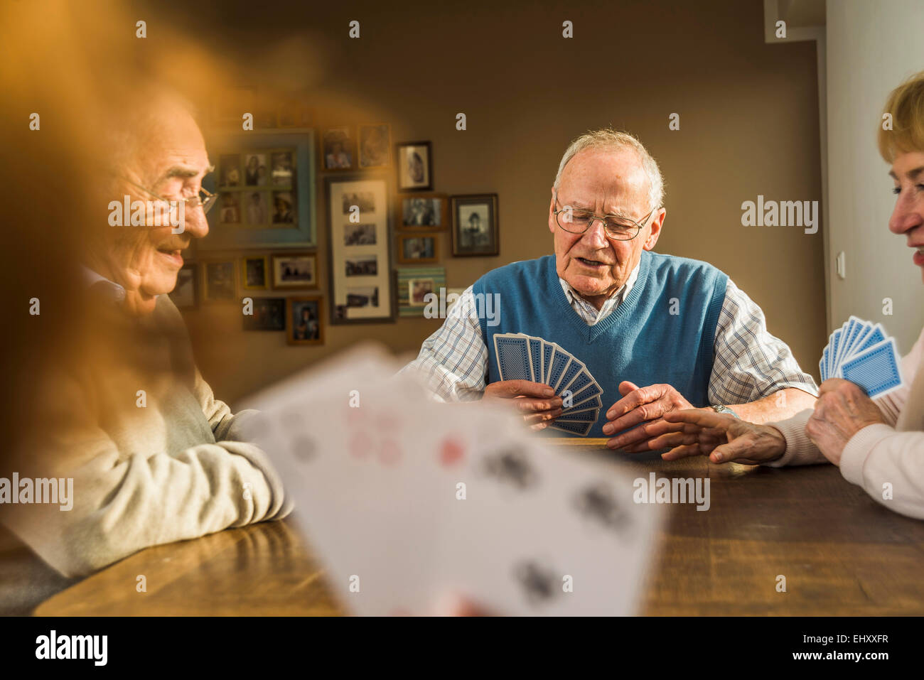 Four friends playing game cards hi-res stock photography and images - Alamy