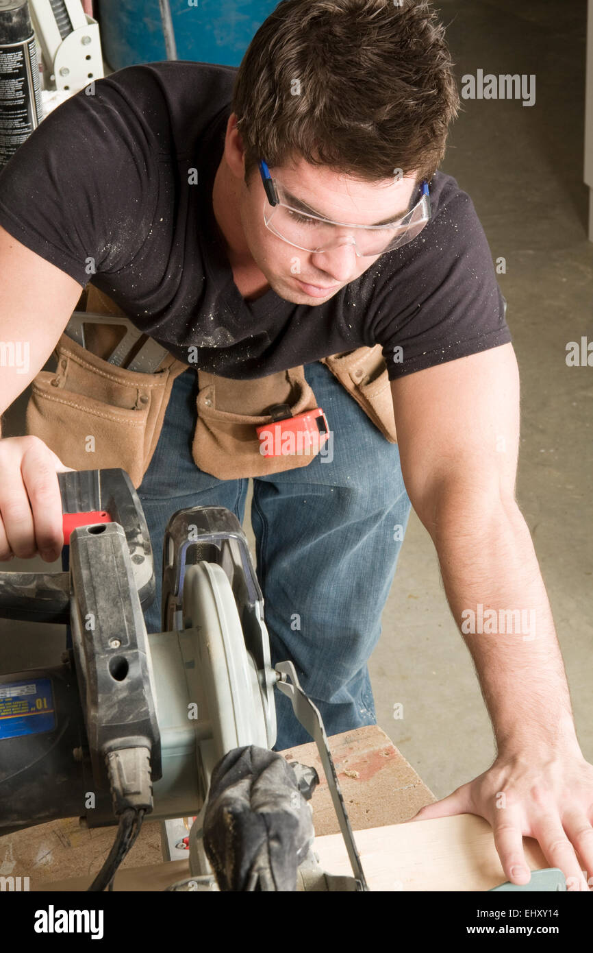 Carpenter at work on job using power tool Stock Photo - Alamy