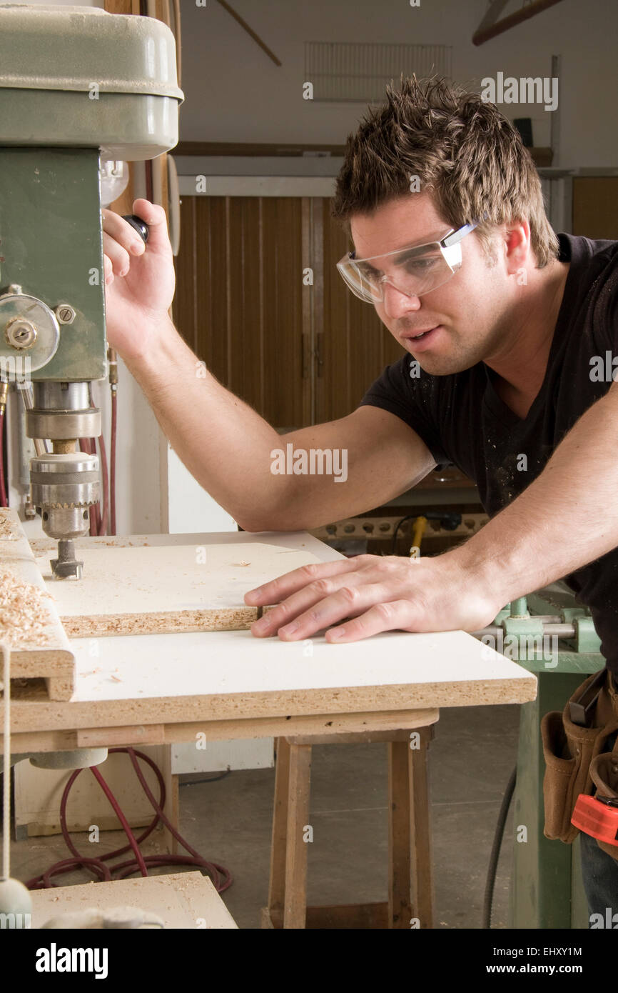 Carpenter at work on job using power tool Stock Photo - Alamy