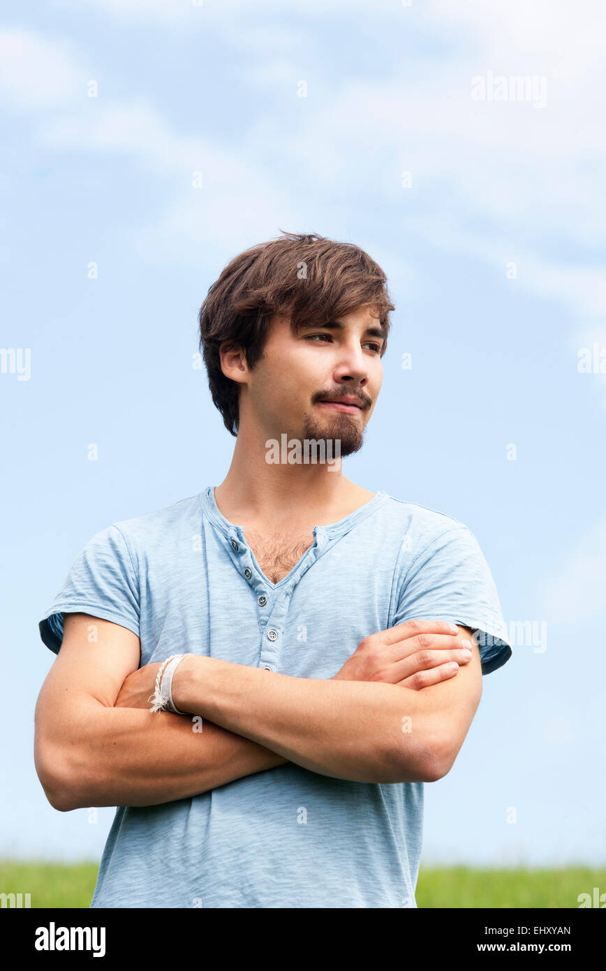 Portrait of young man with crossed arms Stock Photo - Alamy