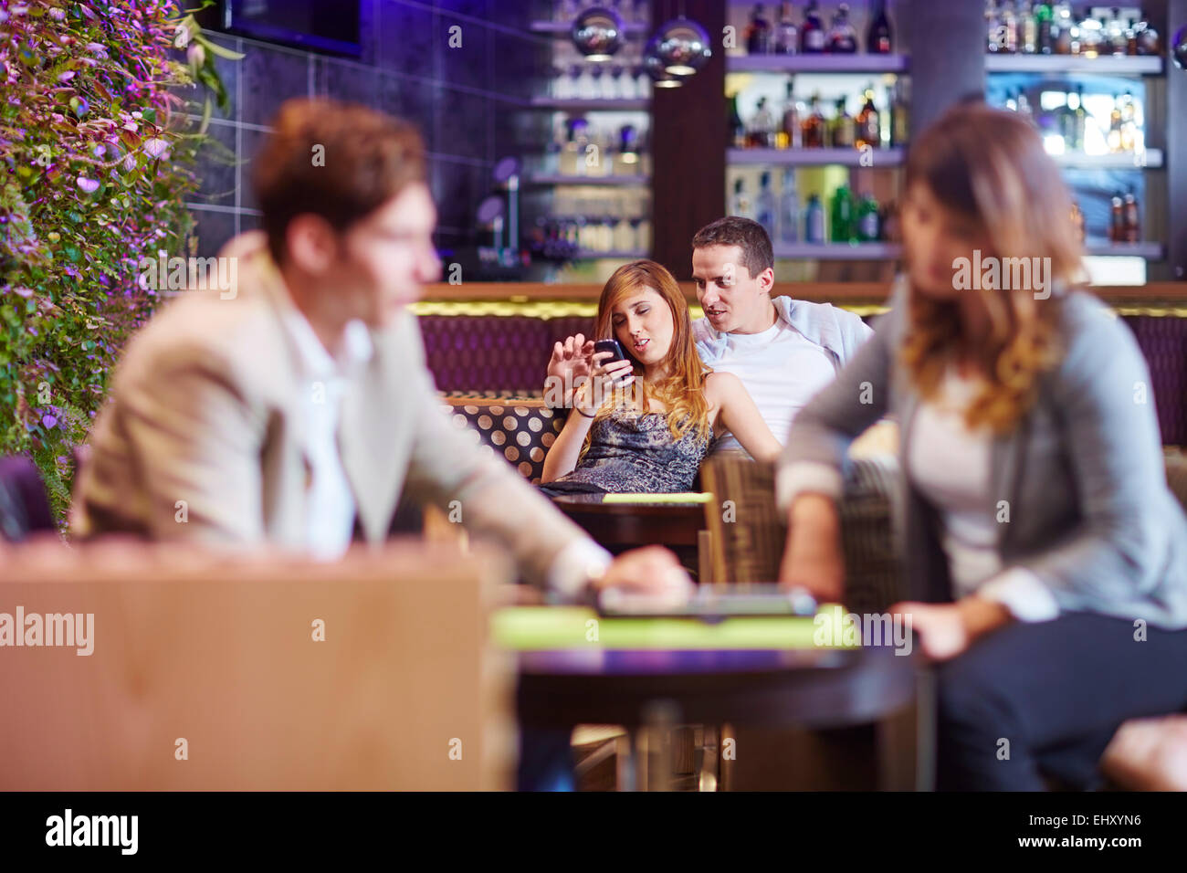 Couple socializing at hotel bar Stock Photo - Alamy