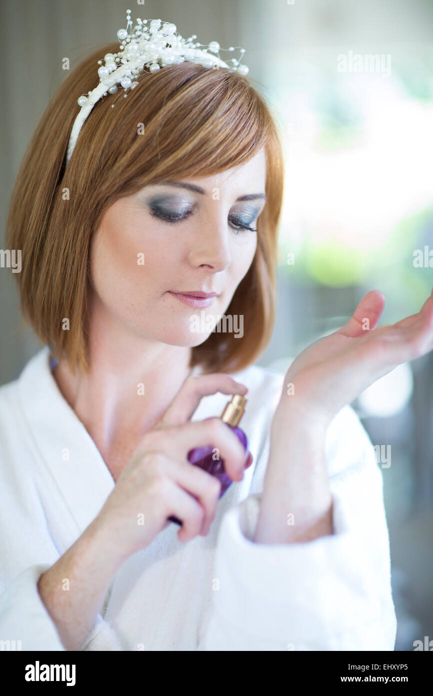 Young woman applying fragrance Stock Photo - Alamy