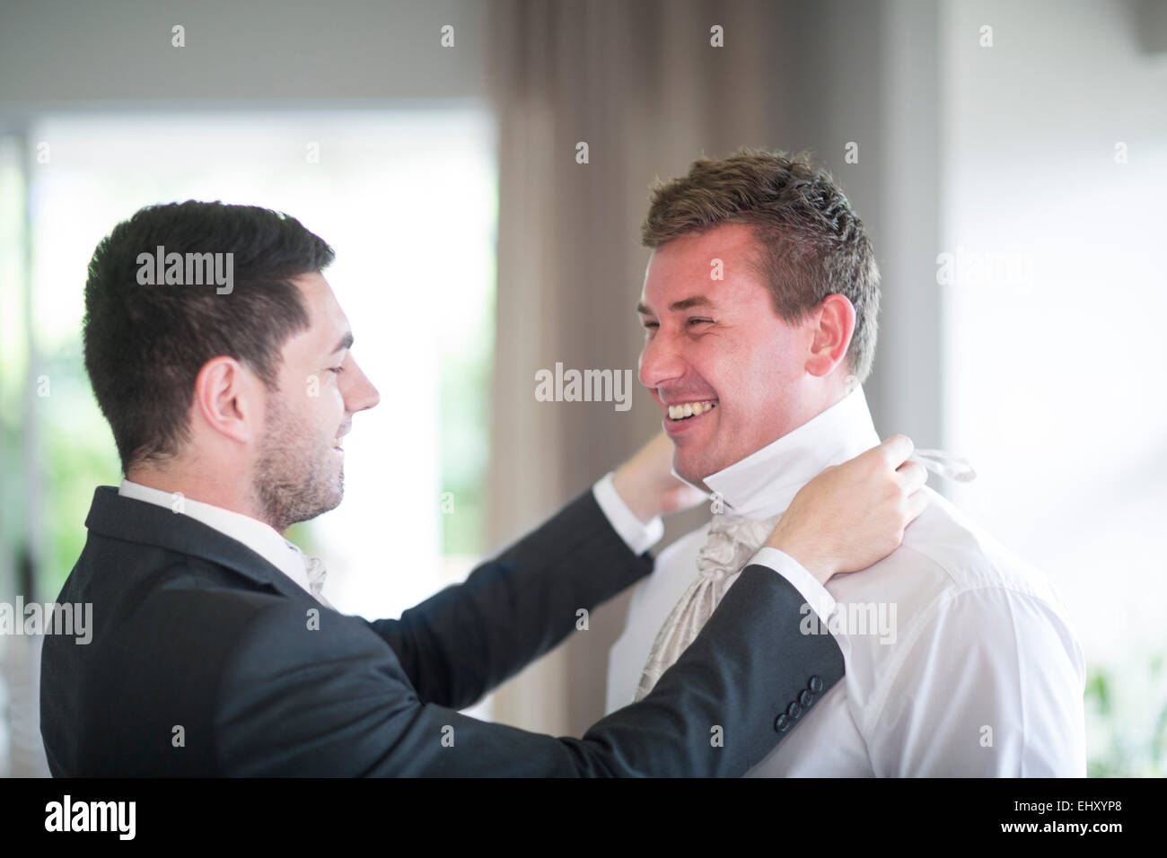 Groom getting ready for wedding with best man Stock Photo - Alamy