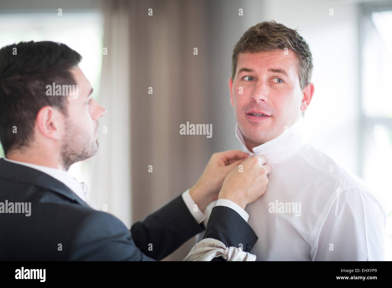 Groom getting ready for wedding with best man Stock Photo - Alamy