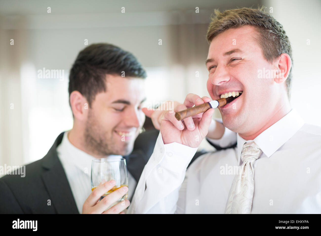 Well dressed man smoking a cigar or cigarette hi-res stock photography ...