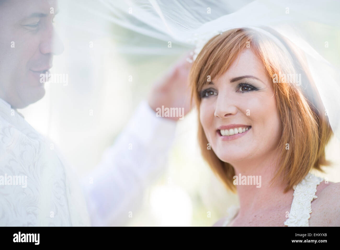 Happy groom and bride covered with veil ready for her wedding Stock ...