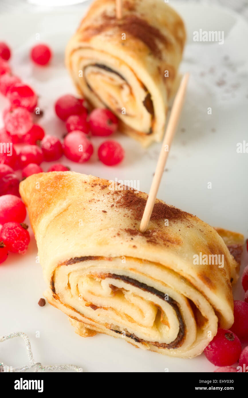 Rolled crepes with red currant Stock Photo - Alamy