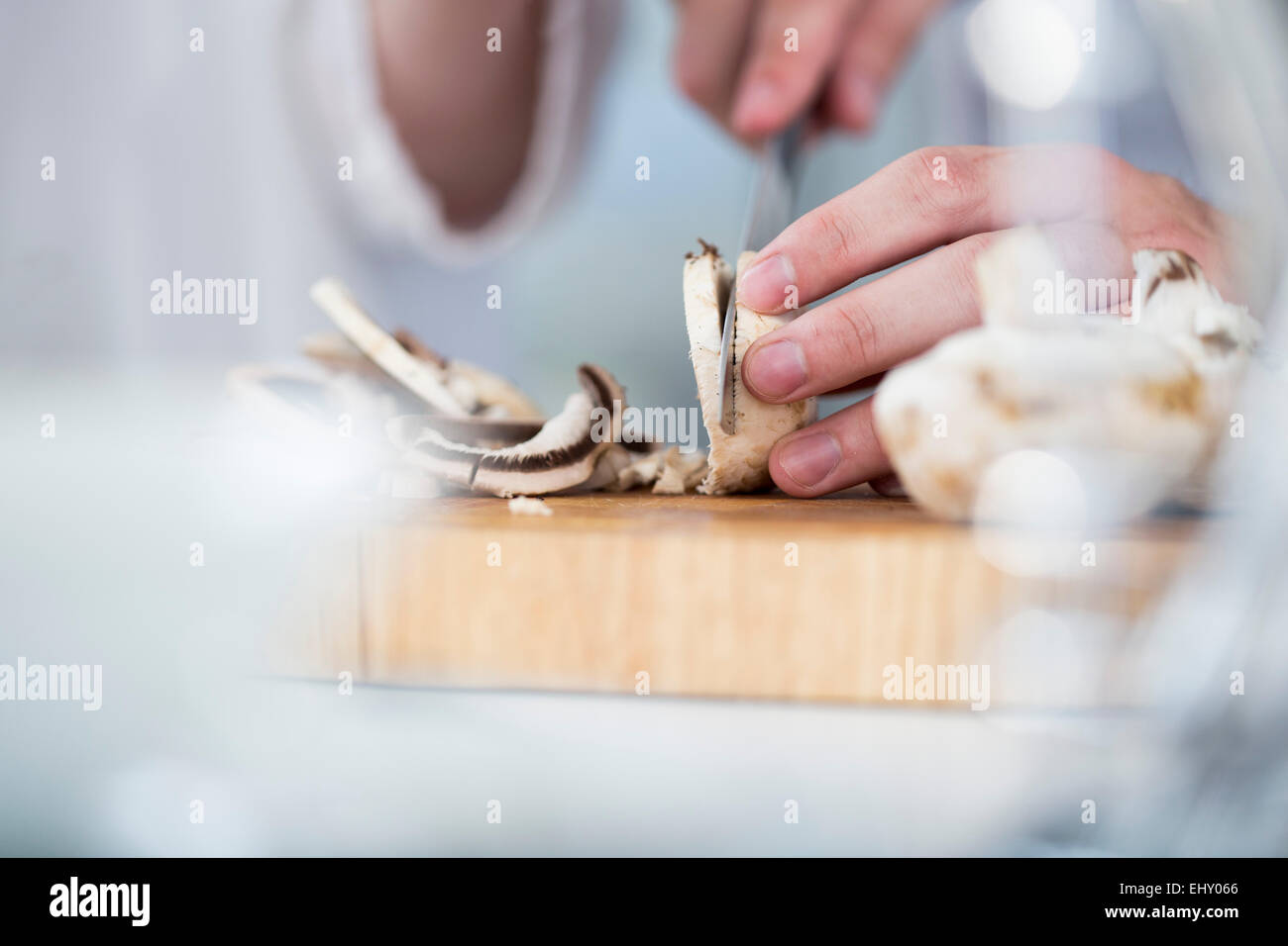 Cutting mushrooms in kitchen Stock Photo - Alamy