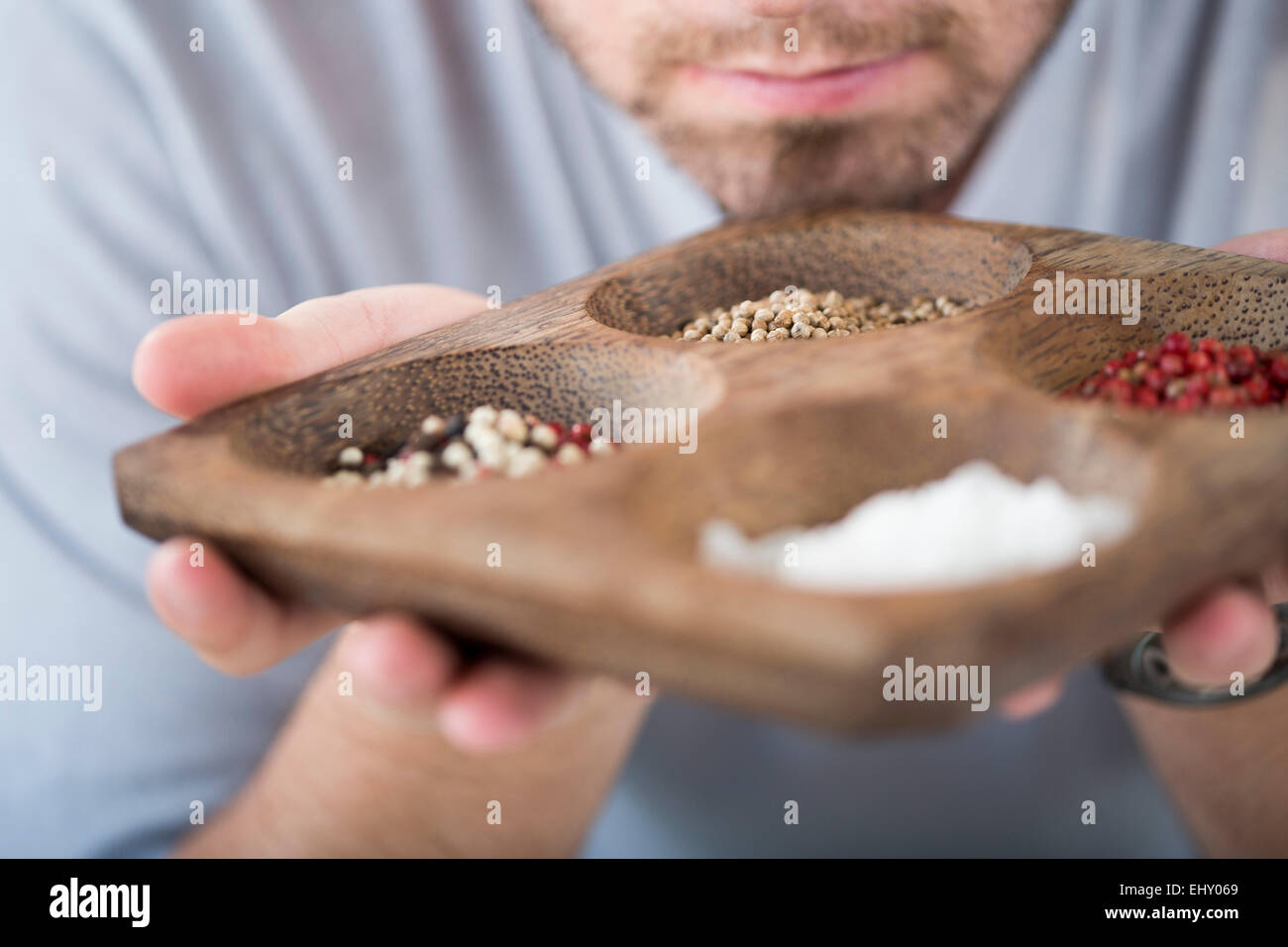 Man holding a bowl and smelling spices Stock Photo - Alamy