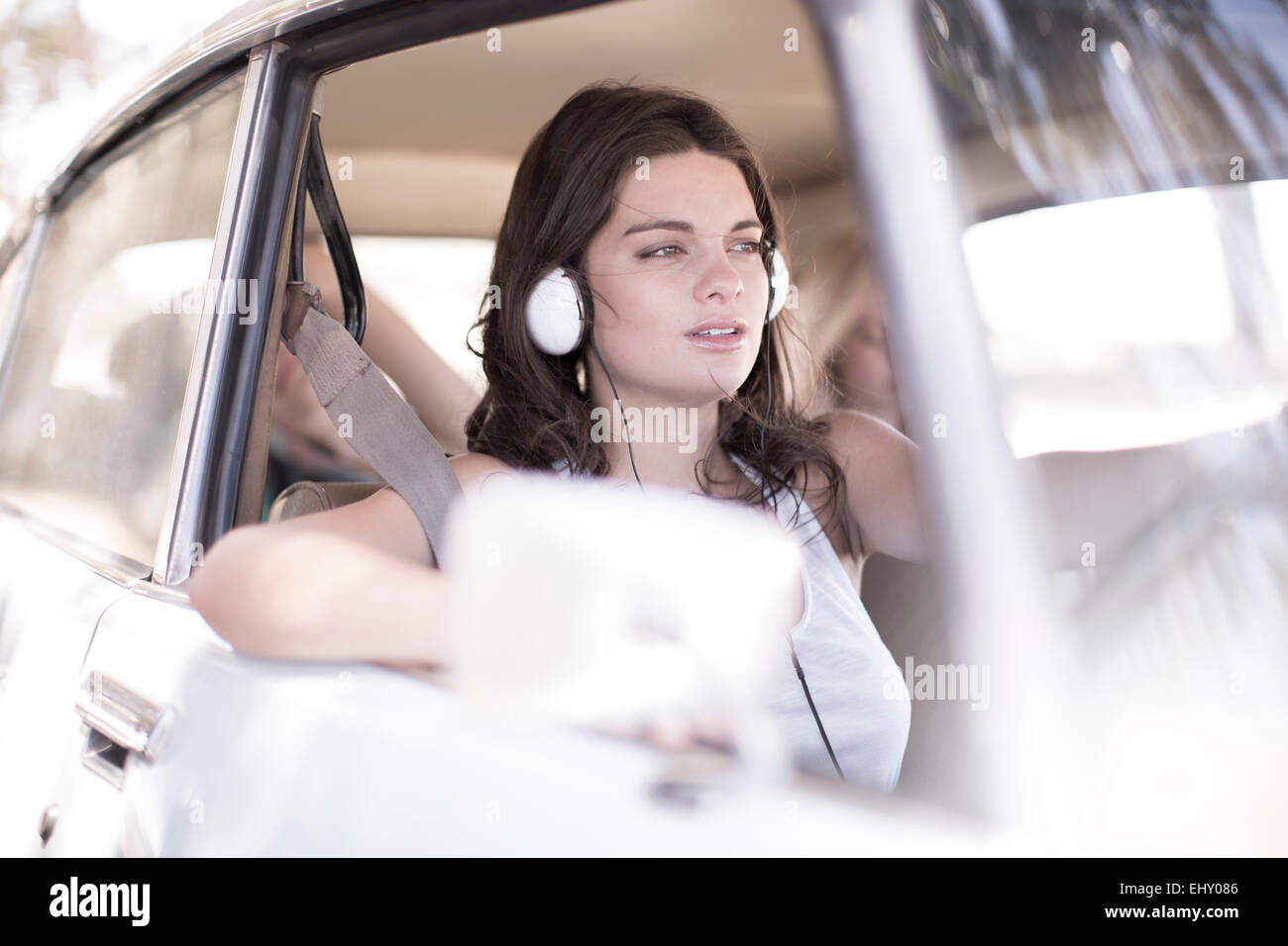 South Africa, Friends on road trip driving in car listening to music ...