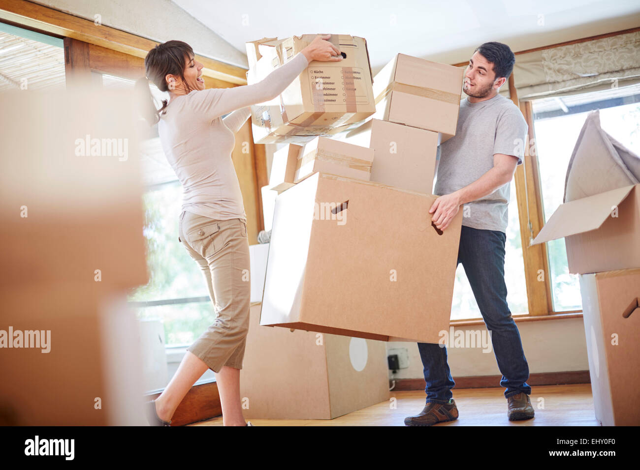 Couple moving house stacking boxes Stock Photo - Alamy