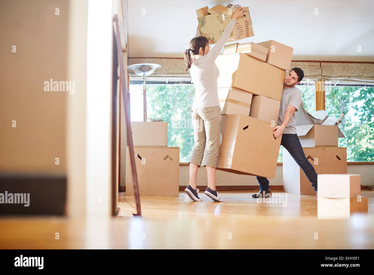 Couple moving house stacking boxes Stock Photo - Alamy