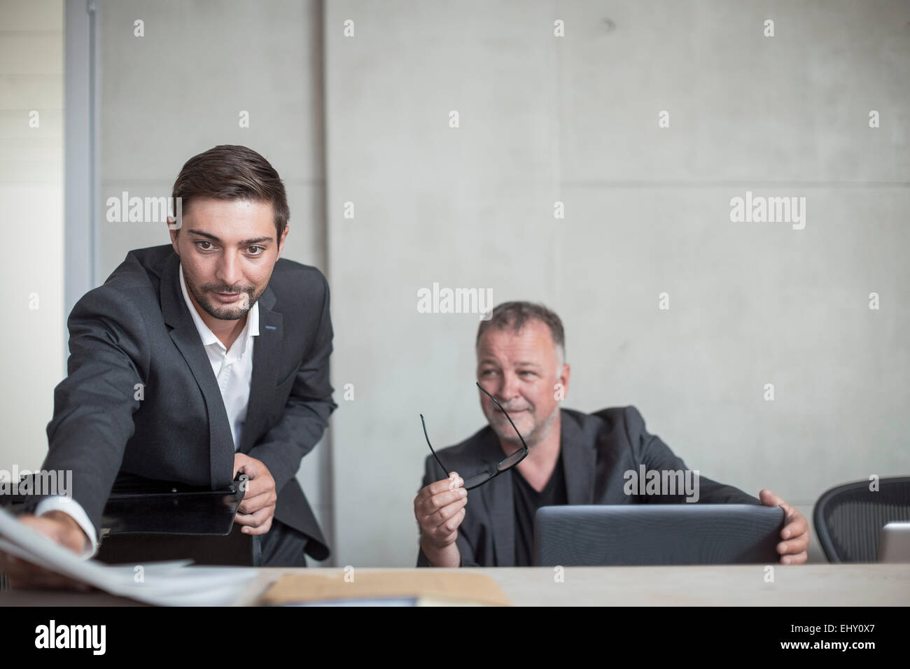 Two businessmen preparing for a meeting in conference room Stock Photo ...