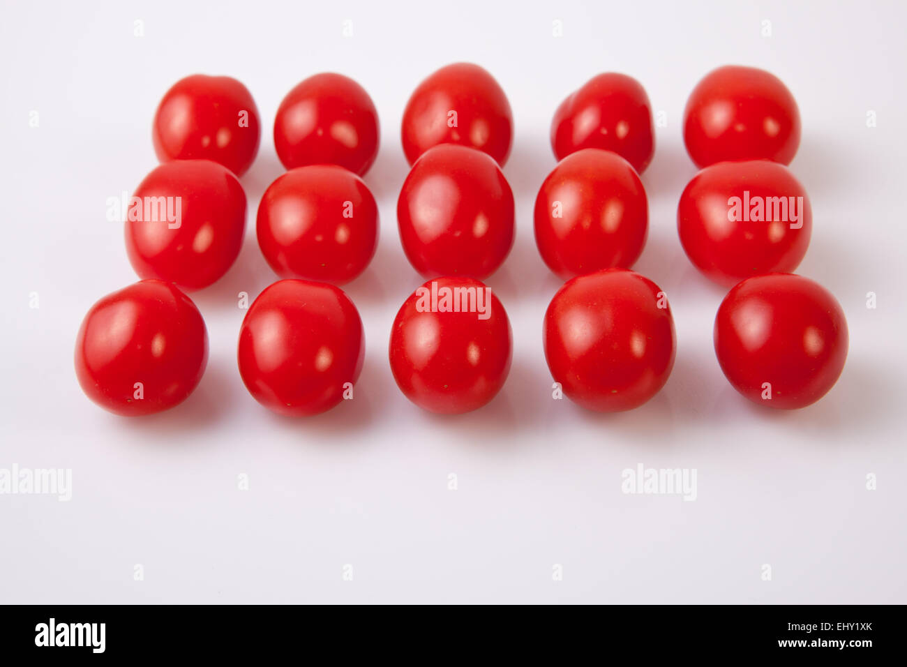 Red shiny cherry tomatoes. Isolated over white background Stock Photo ...