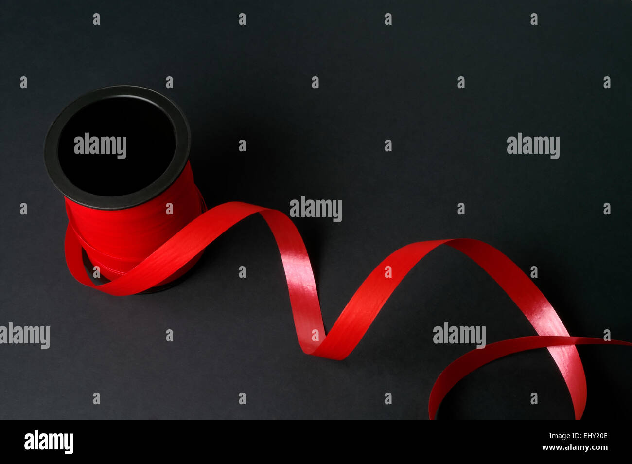 Red tape on black background Stock Photo - Alamy