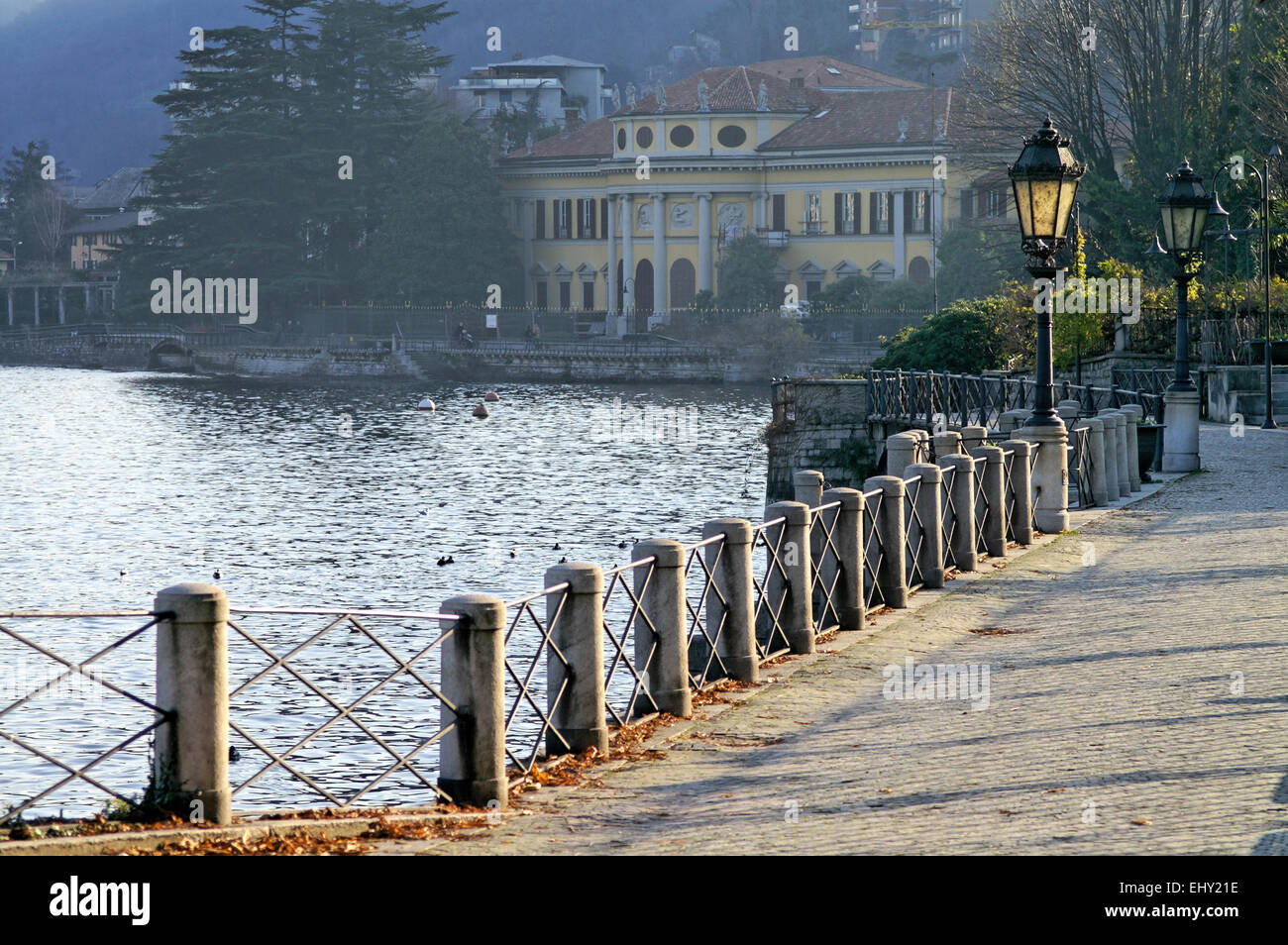 Lakeside walkway with old mansion in the background Stock Photo - Alamy