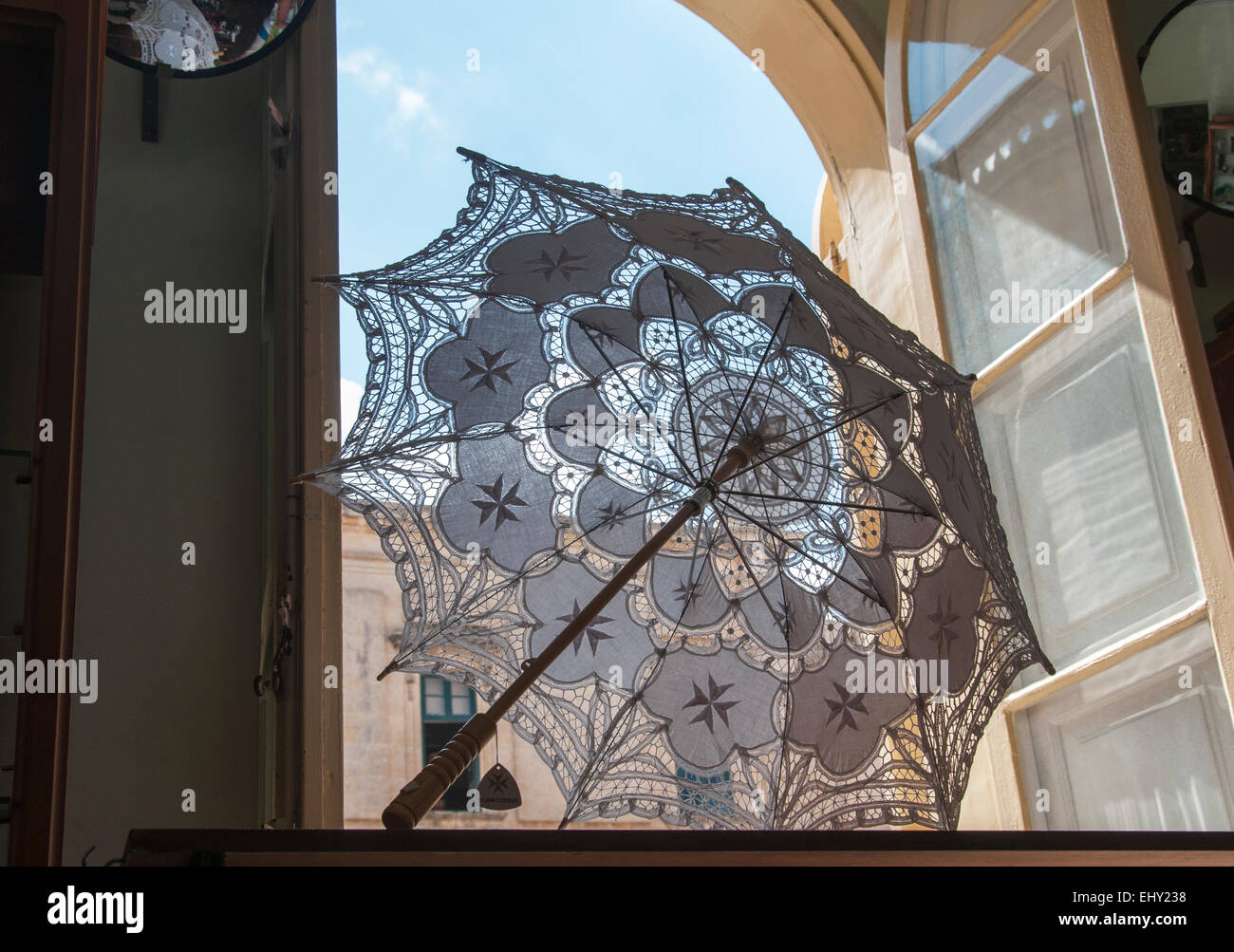 old handmade umbrella or parasol in window Stock Photo - Alamy