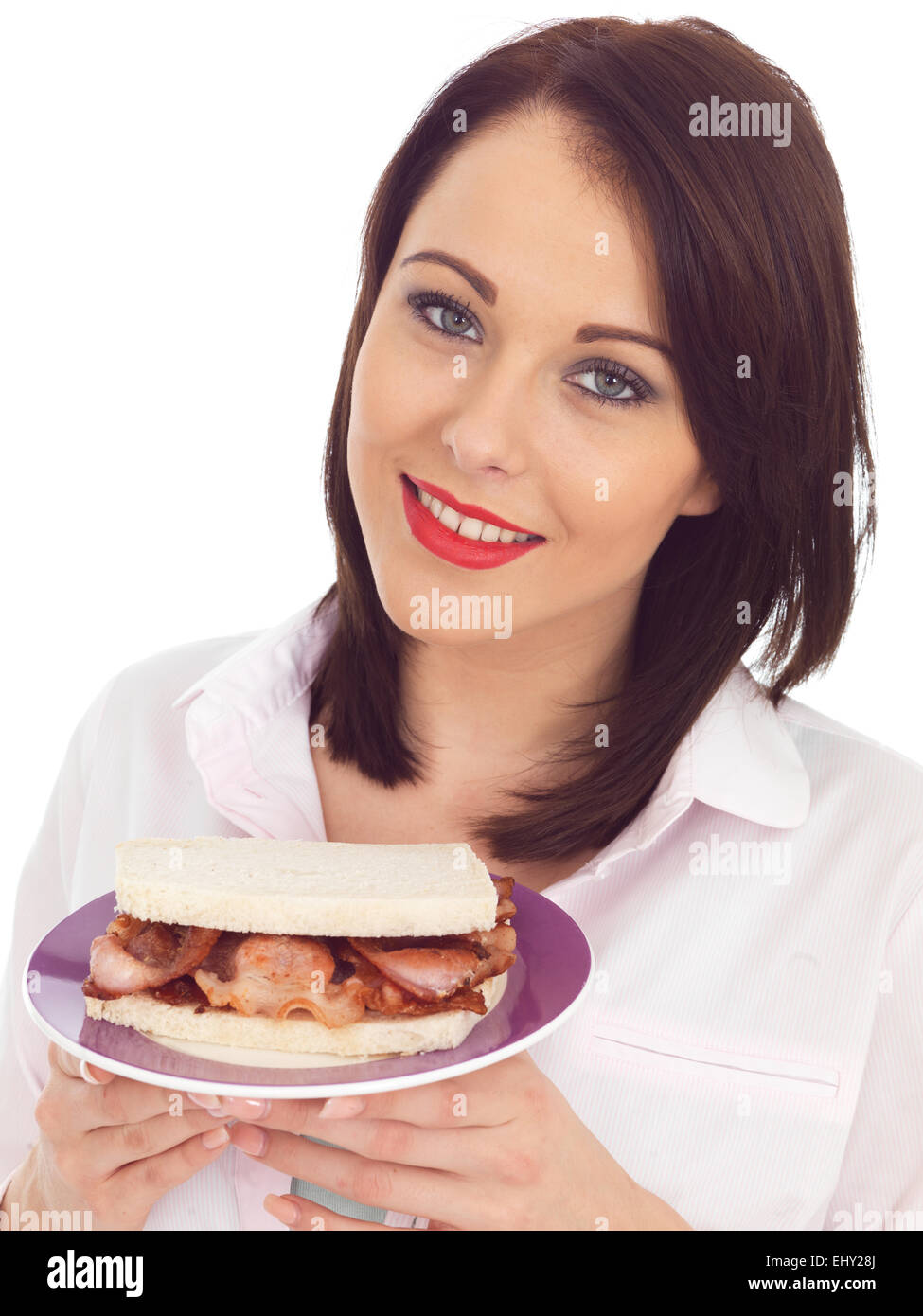 Attractive Young Woman Eating a Bacon Sandwich Stock Photo - Alamy