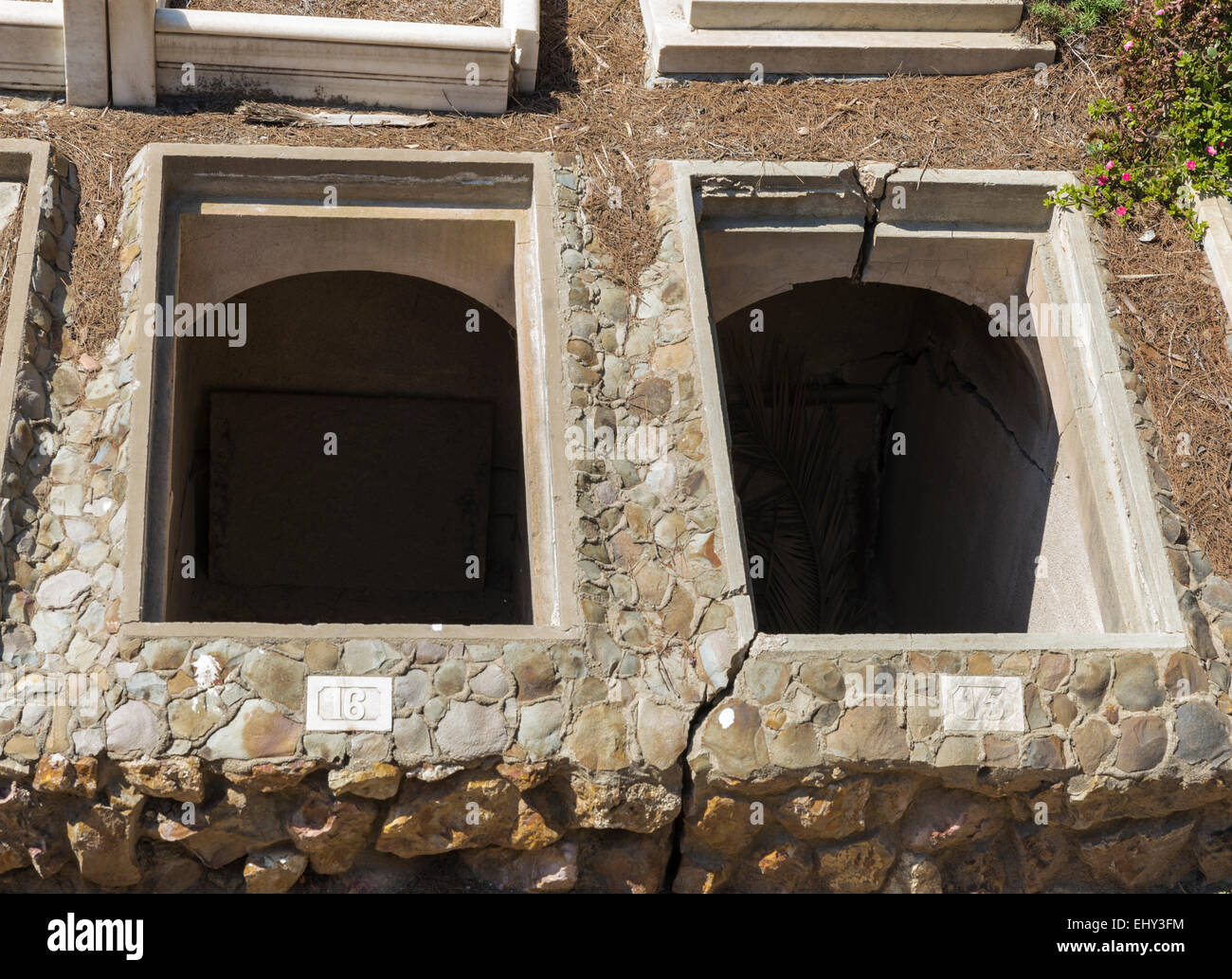 Open and empty tomb in a cemetery. The tomb is at ground level Stock ...