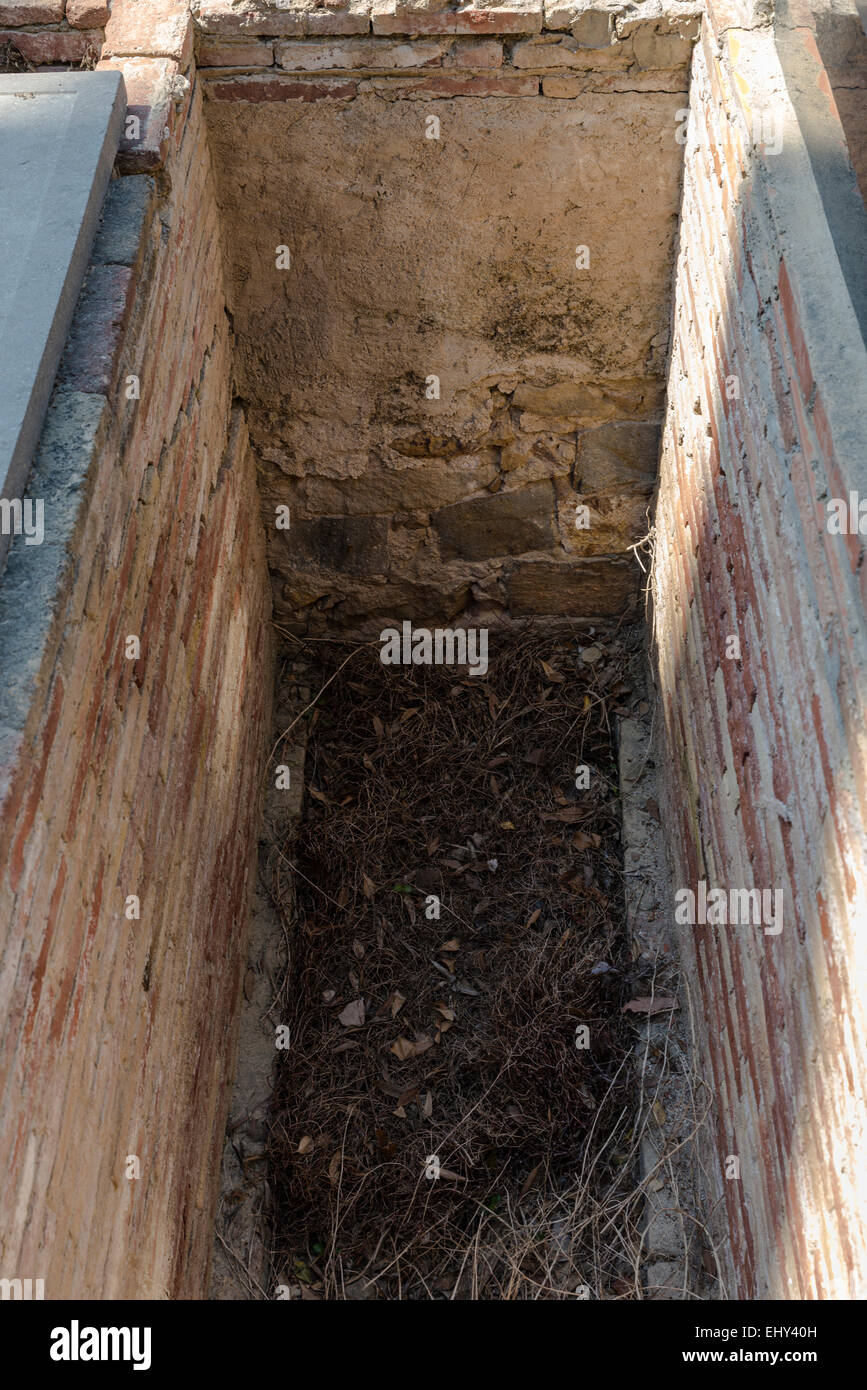 Open and empty tomb in a cemetery. The tomb is at ground level Stock ...
