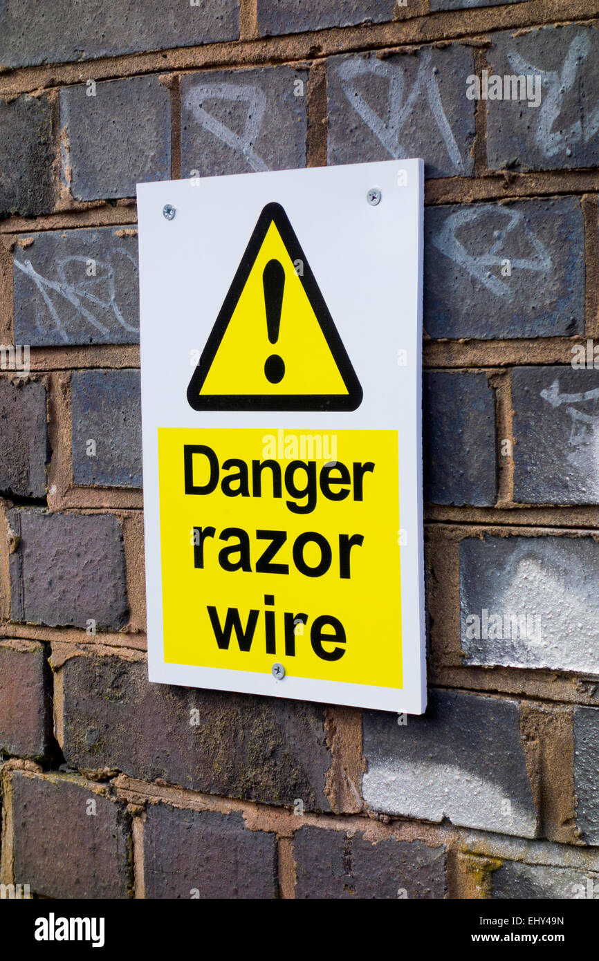Yellow danger razor wire sign hi-res stock photography and images - Alamy