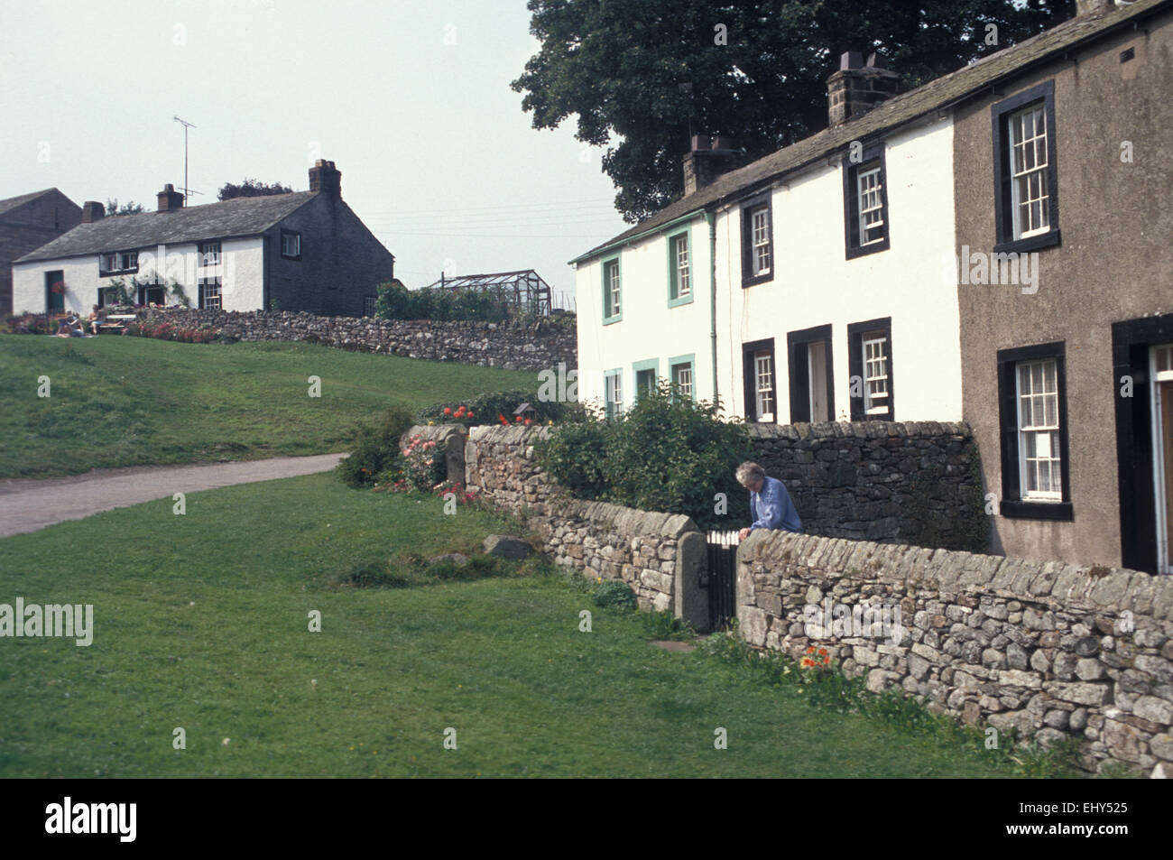 A woman at her front gate in Askham Village Near Penrith Cumbria Stock ...