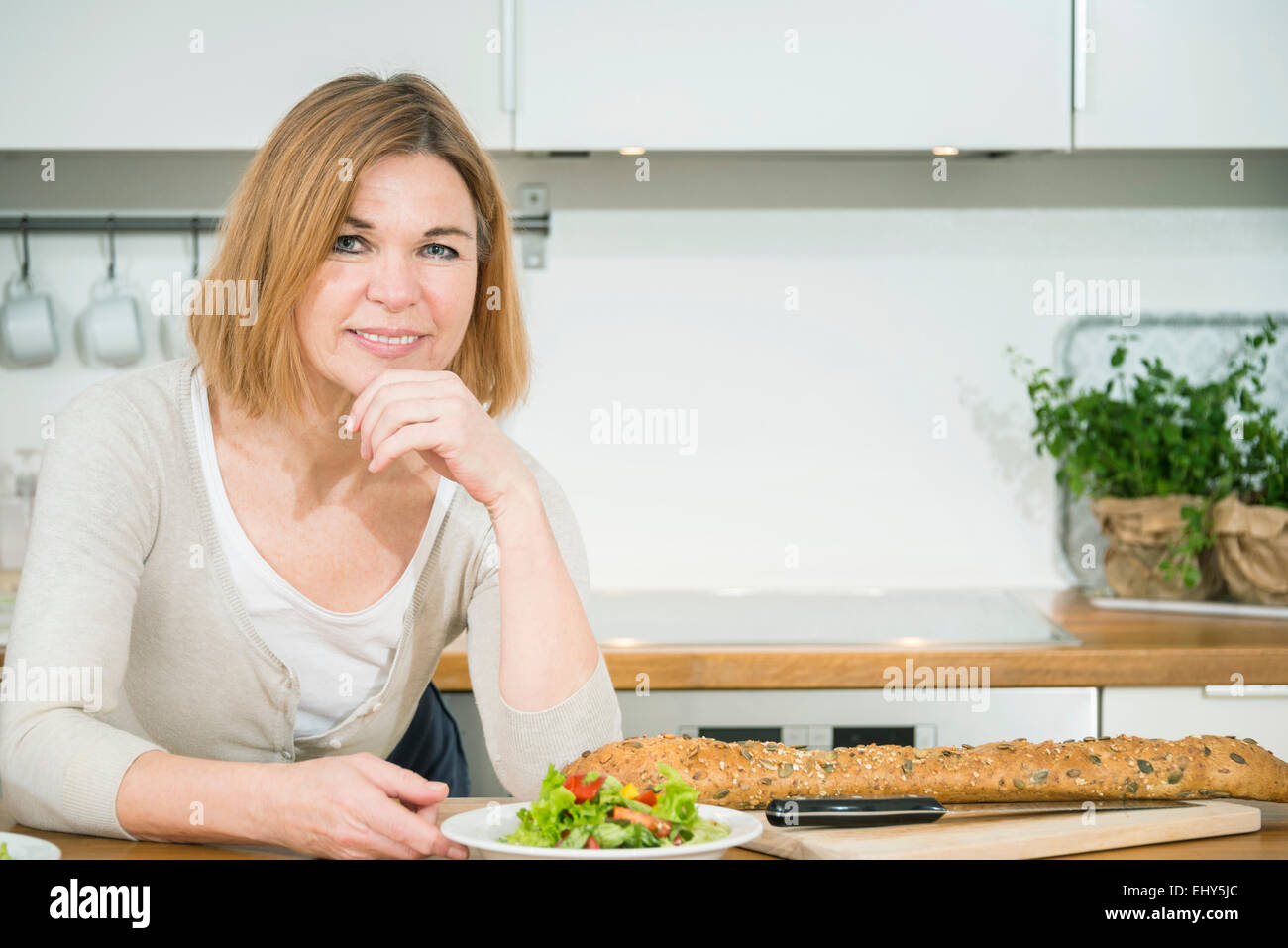 Sitting one hand on chin kitchen hi-res stock photography and images ...