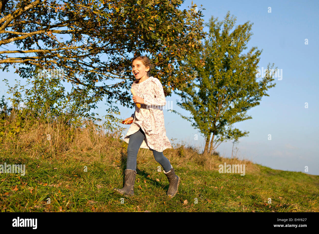 Girl running in field Stock Photo - Alamy