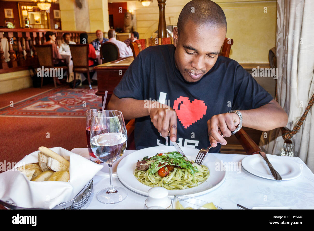 Interior inside black african man male lunch eating pasta dining hi-res ...