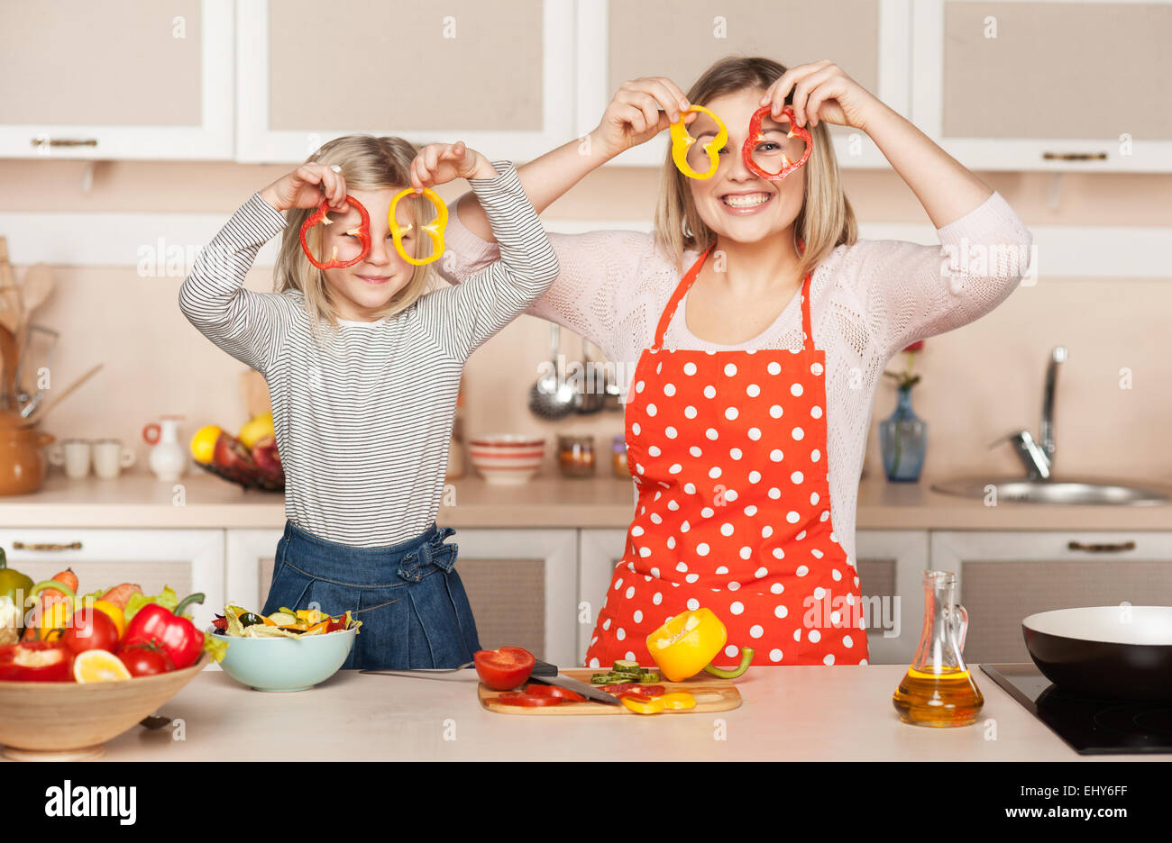 Young mother and her daughter having fun while cooking Stock Photo - Alamy