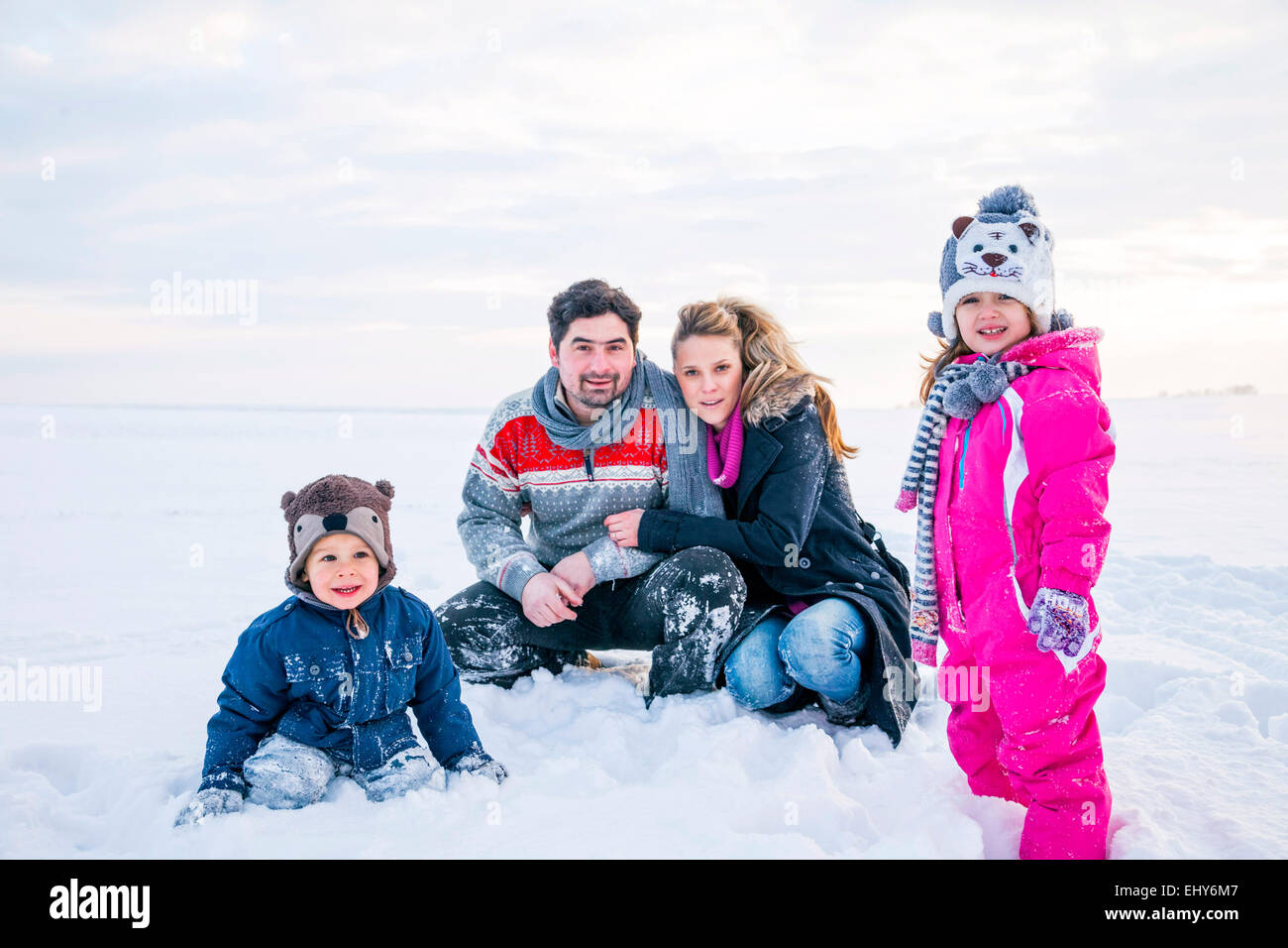 Happy family in snow Stock Photo - Alamy