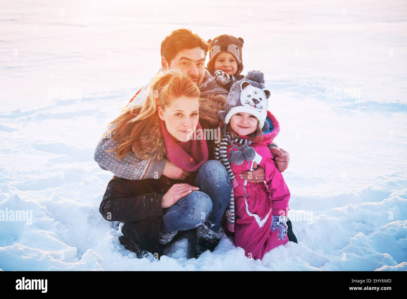Happy family in snow Stock Photo - Alamy