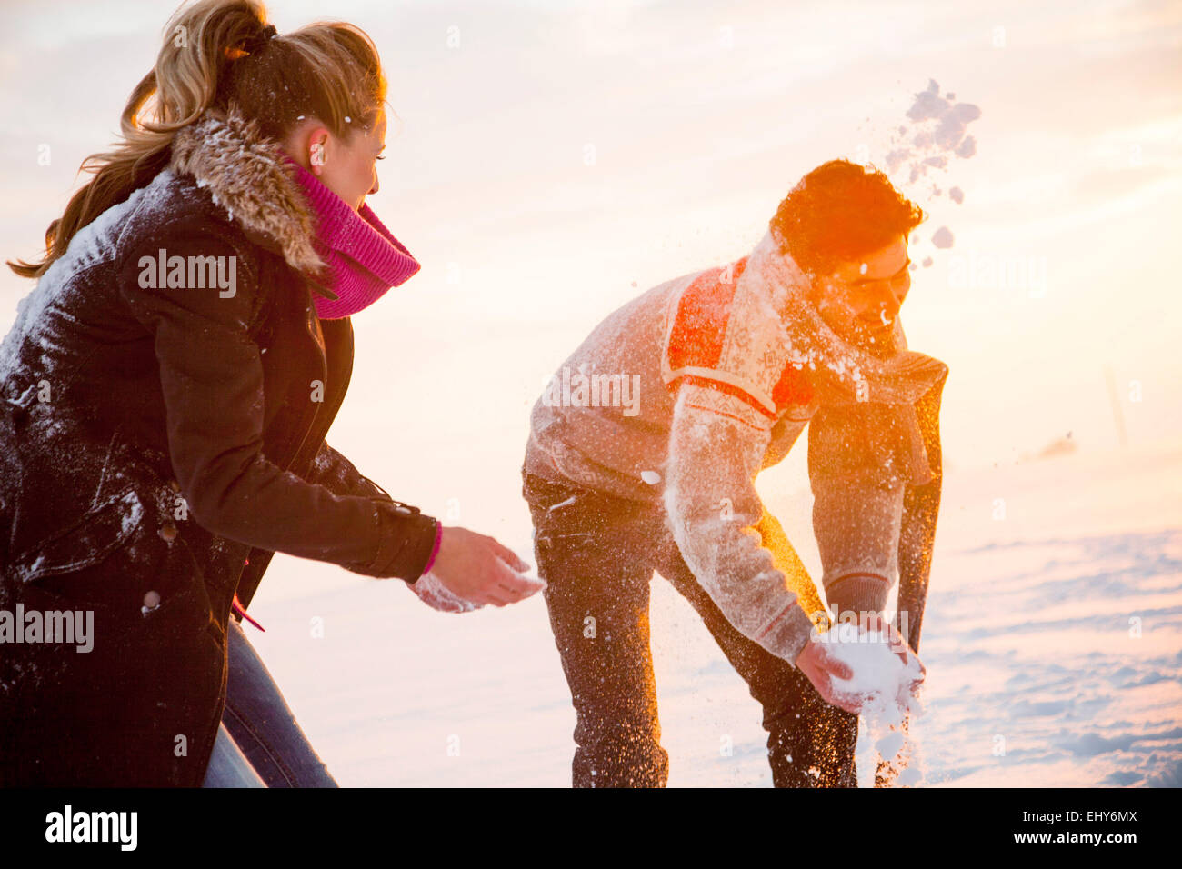 Couple having snowball fight Stock Photo - Alamy