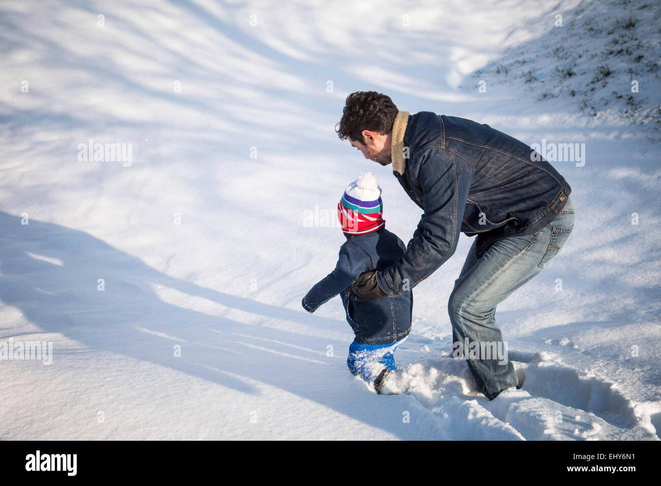 Father and son playing in snow Stock Photo - Alamy