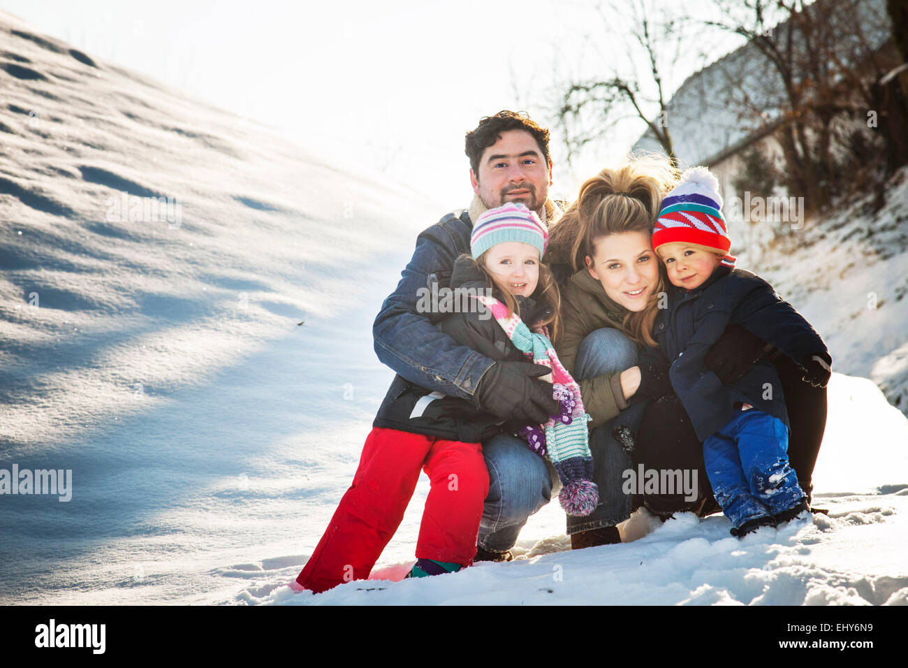Happy family in snow Stock Photo - Alamy