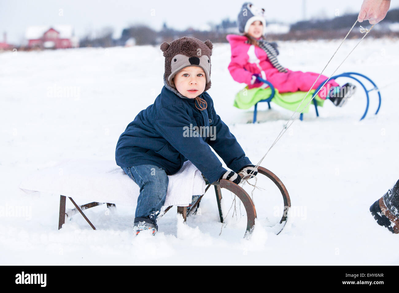 Two children on sled Stock Photo - Alamy