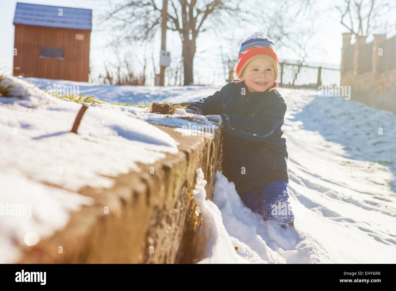 Little boy playing in snow Stock Photo - Alamy