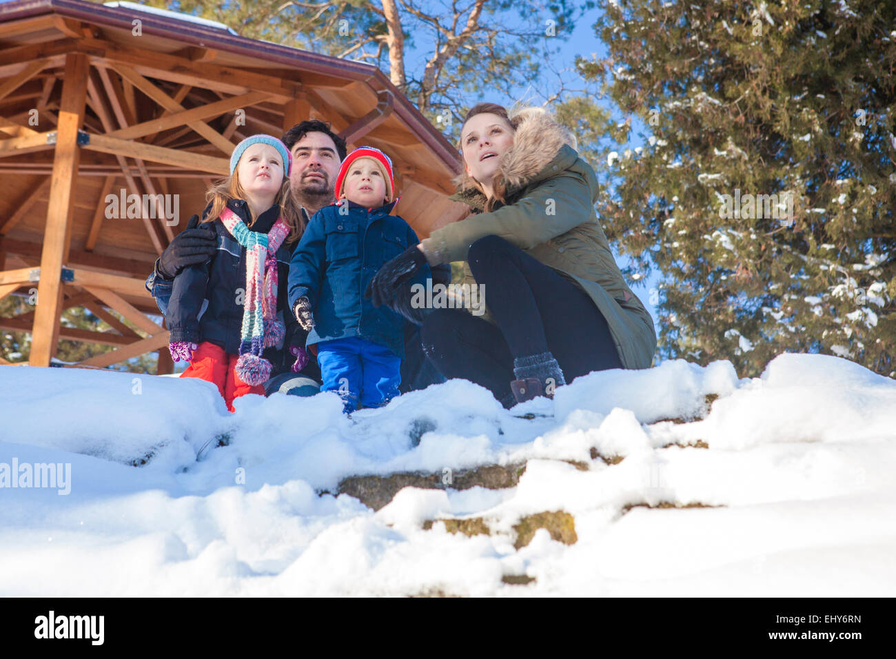 Happy family in snow Stock Photo - Alamy