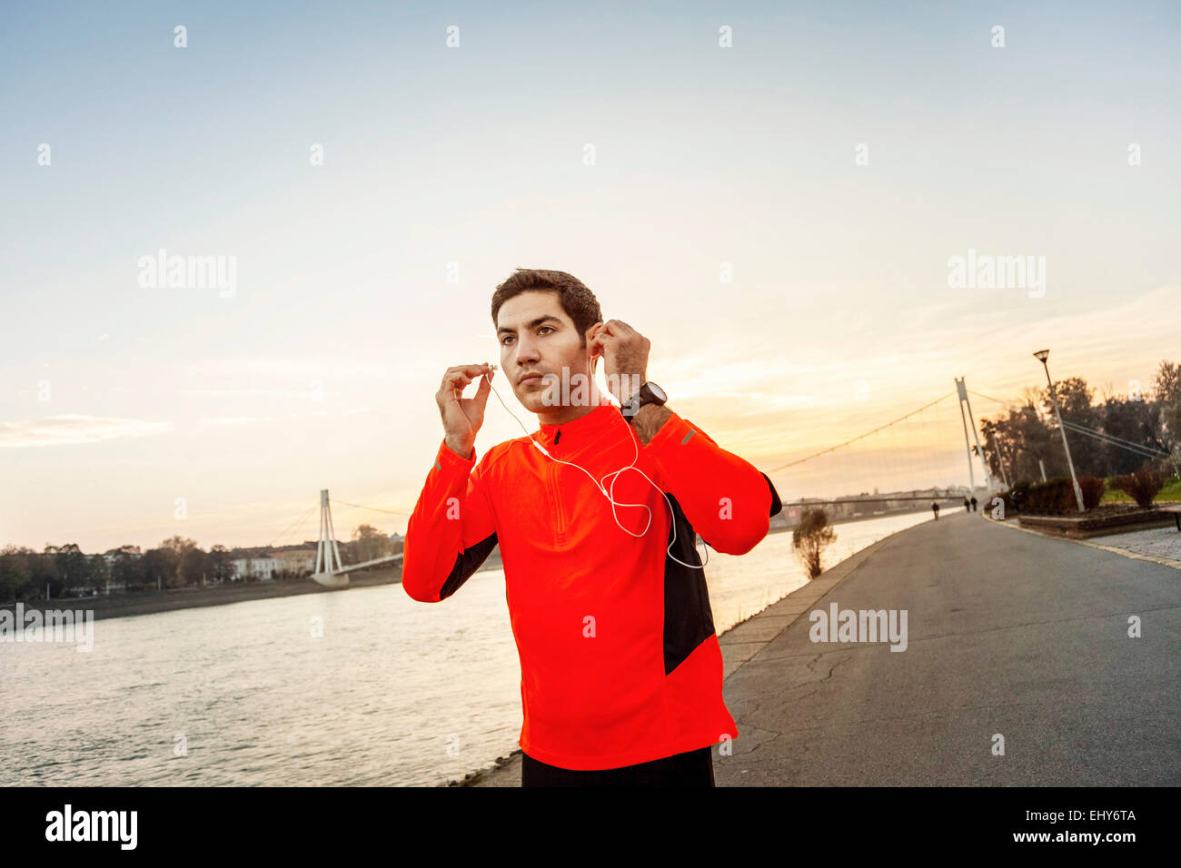 Male runner with in-ear headphones on the waterfront Stock Photo - Alamy